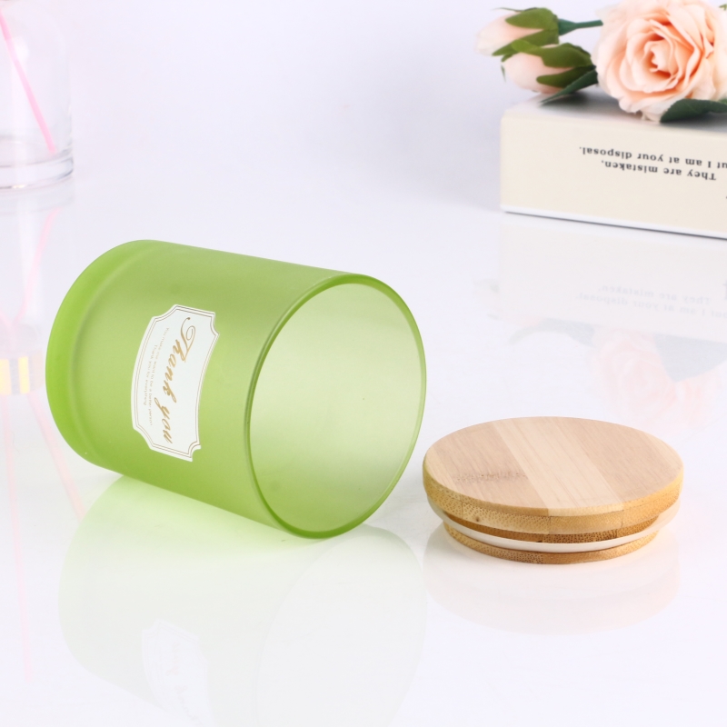 Green translucent glass candle jar