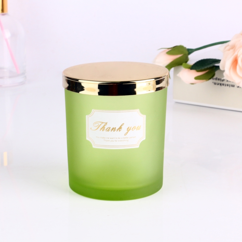 Green translucent glass candle jar