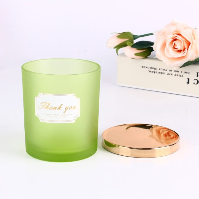 Green translucent glass candle jar