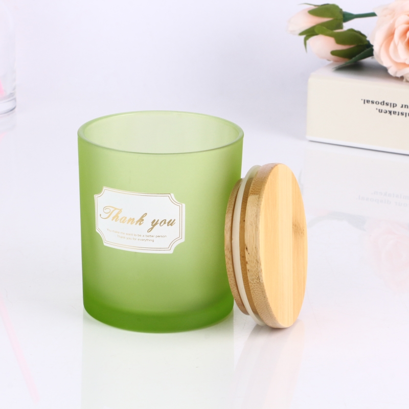 Green translucent glass candle jar