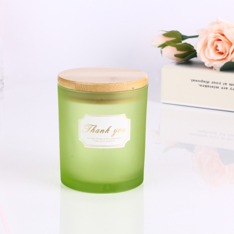 Green translucent glass candle jar